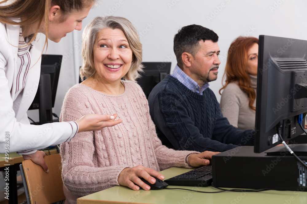 Business woman helping to partners, pointing at computer monitor Stock ...