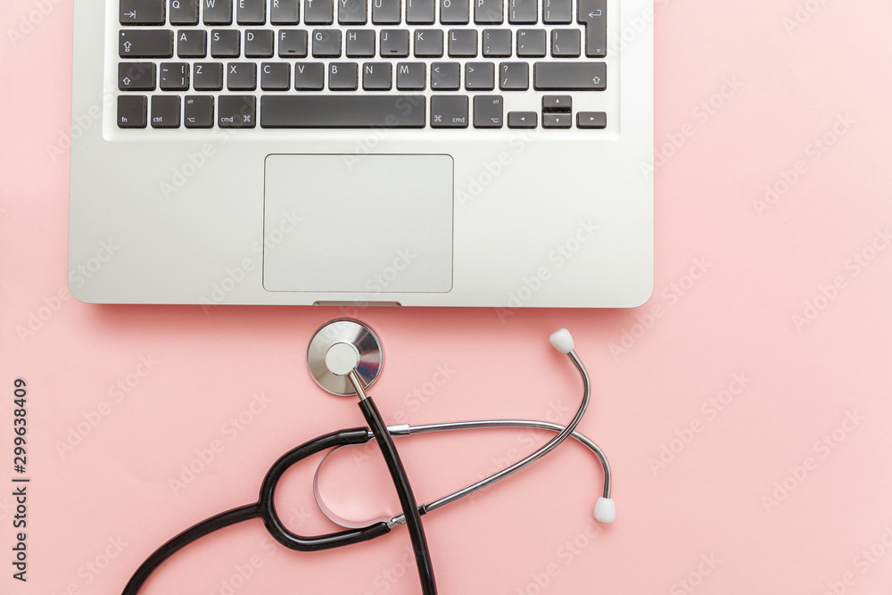 Stethoscope keyboard laptop computer isolated on pink background ...
