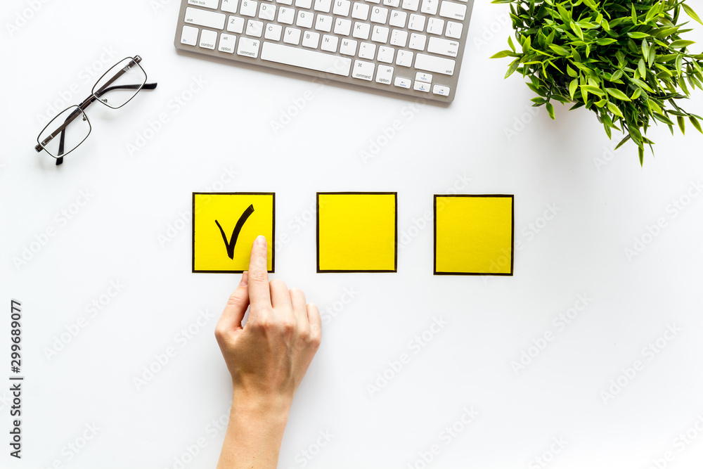 Hand put check mark in yellow check-box on white office background top ...