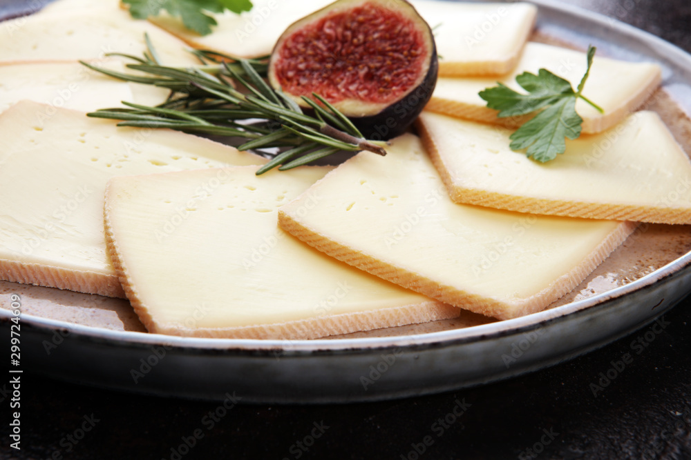 raclette cheese sliced. Very delicious swiss raclette on rustic ...