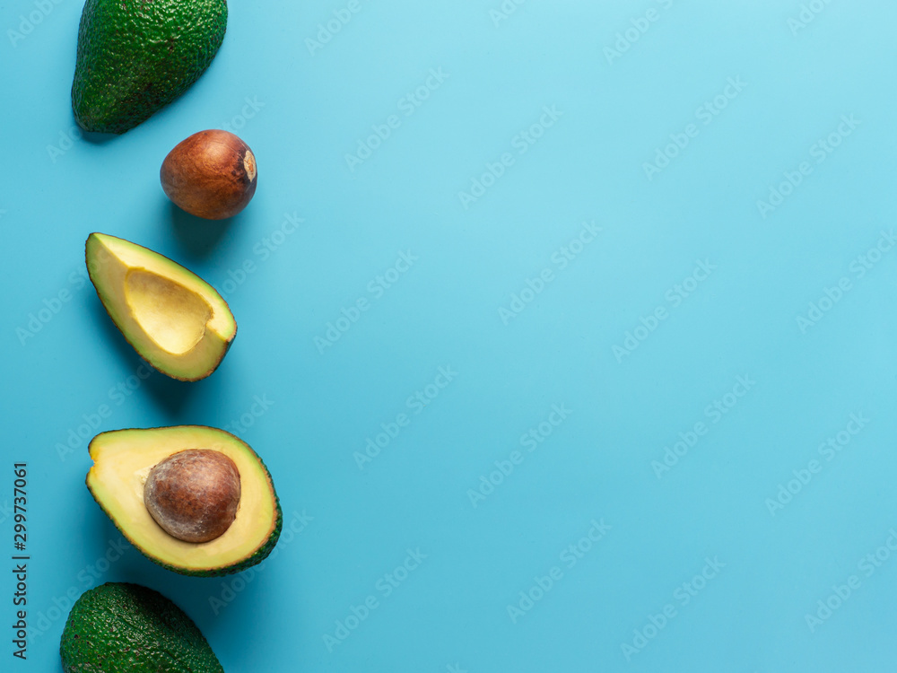 Avocado with copy space. Top view of avocado half, quarter and avocado ...