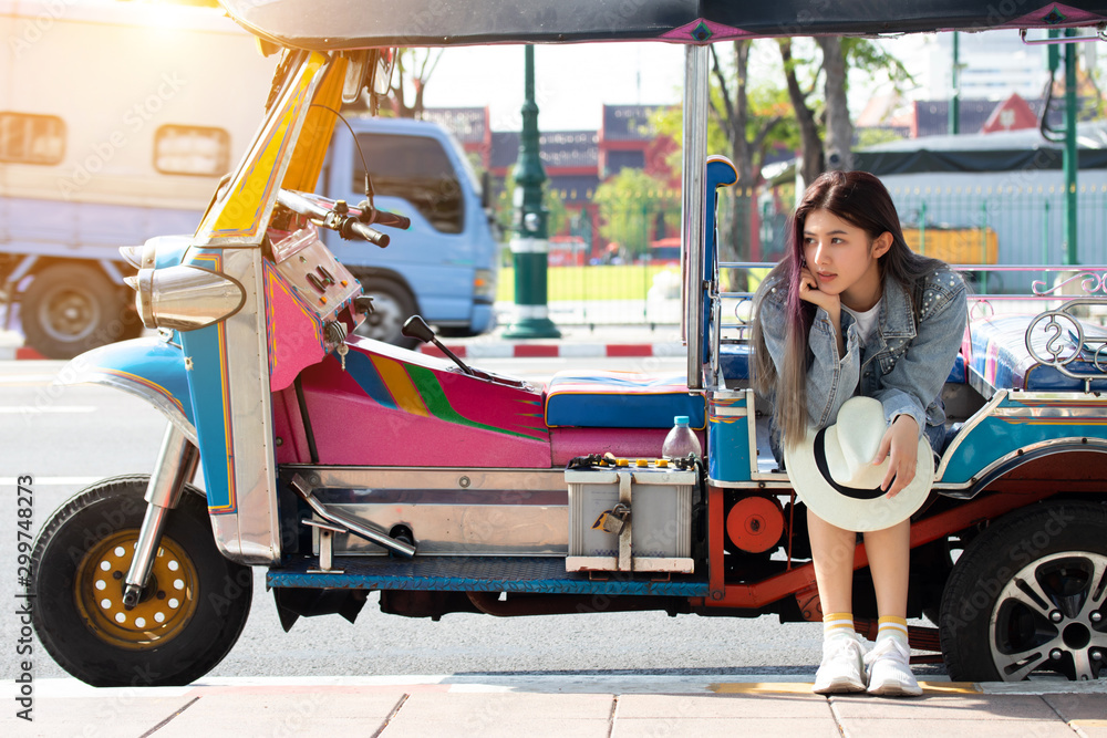Attractive beautiful tourist woman or traveler woman sitting on tuk tuk ...
