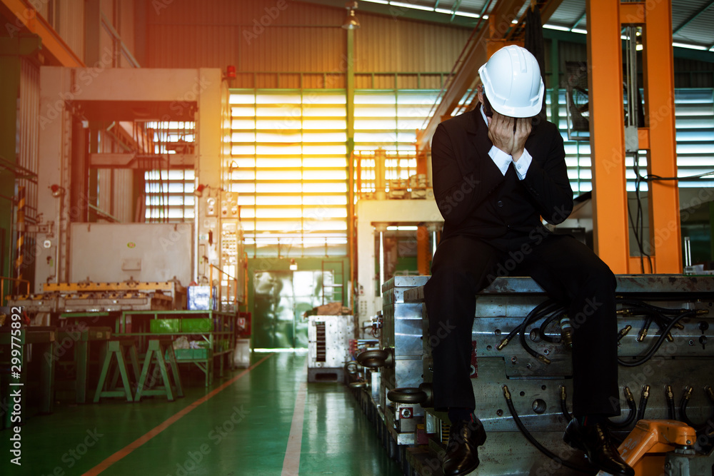 Young bussiness man feel down in factory, business failure or ...