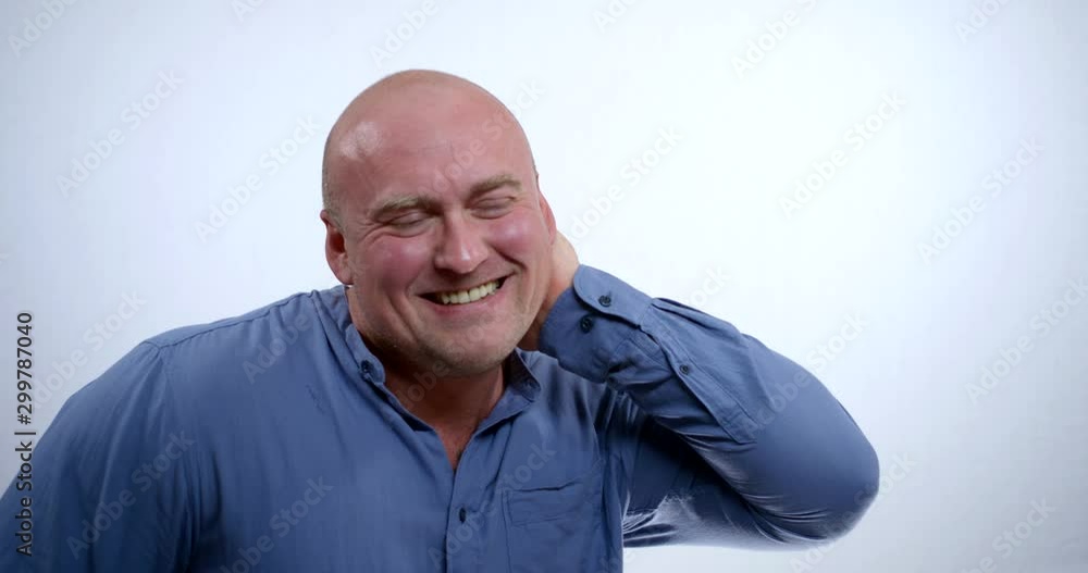 A close-up portrait of an angry, scary bald middle-aged man and in a ...