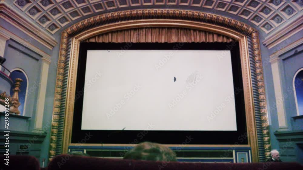 16mm film effect over Large interior of vintage movie theater cinema ...