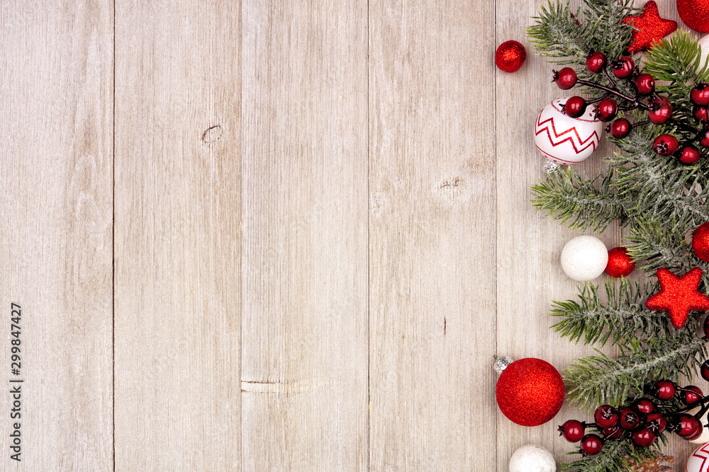 Christmas side border with red and white ornaments and branches. Above ...