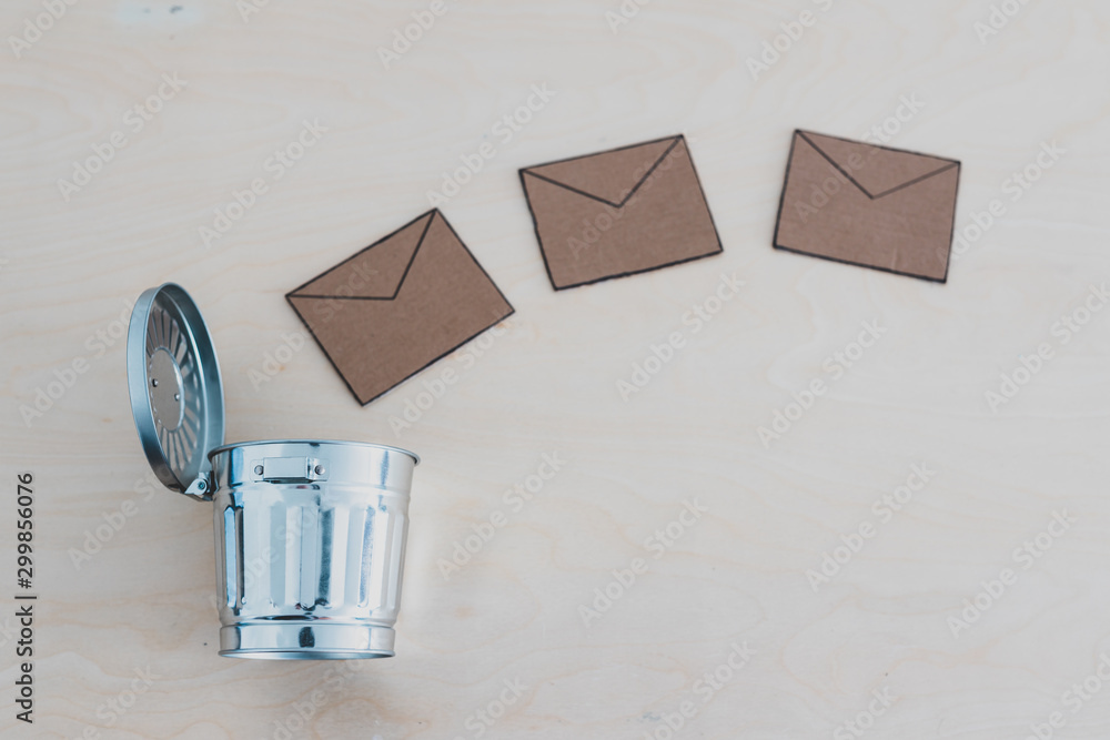 decluttering your inbox, email envelopes and garbage bin on desk Stock ...