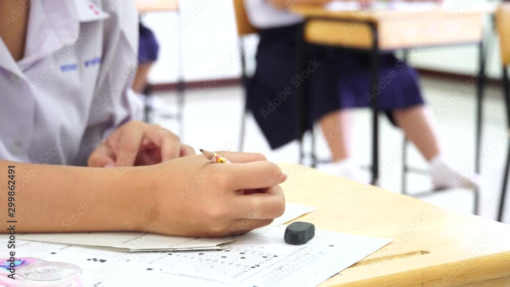 Student testing in exam on exercise sheet, taking at school or ...