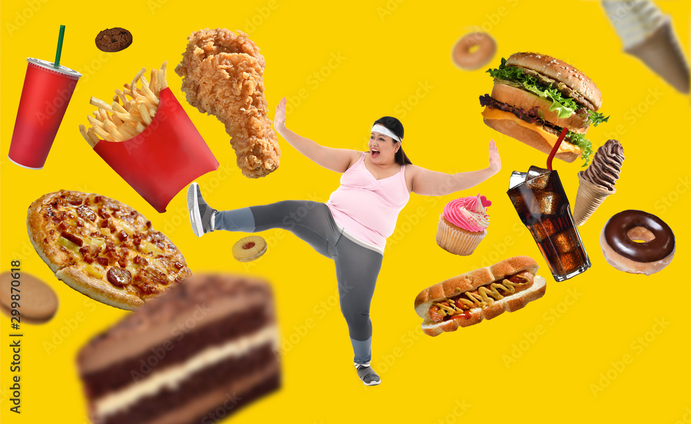 Overweight Asian woman fighting off junk food Stock Photo | Adobe Stock