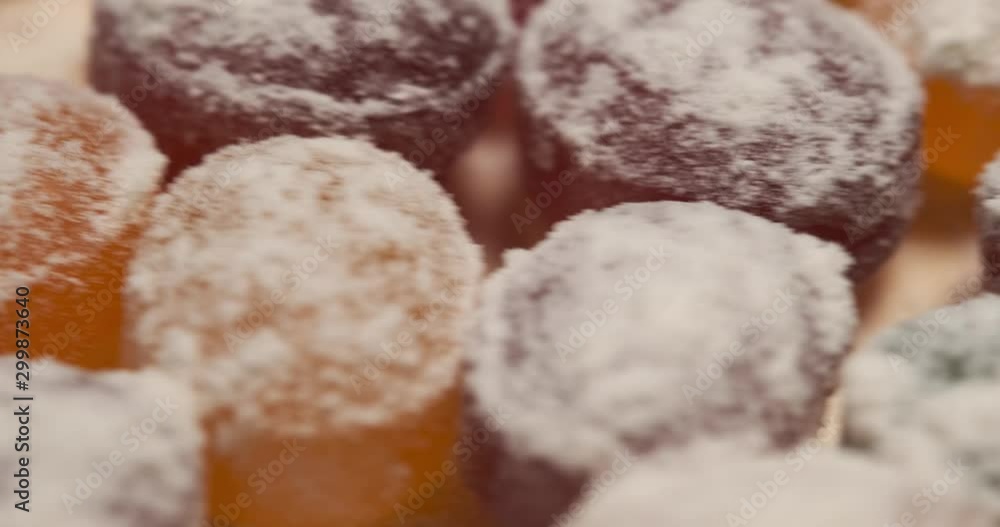 Close-up camera takes pictures of sweets, jellies, caramels rotating on ...