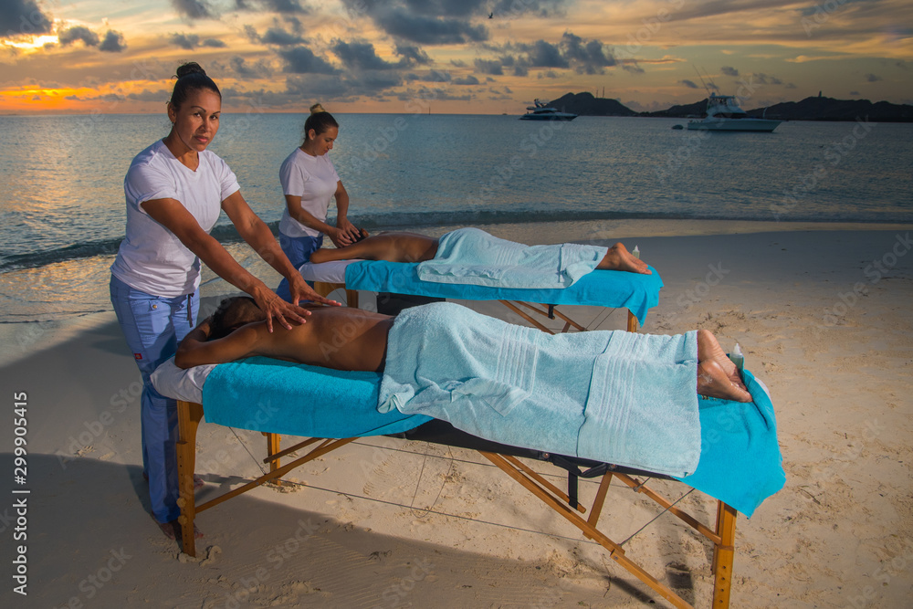Women giving massage therapy stretch head neck outdoor at Caribbean ...