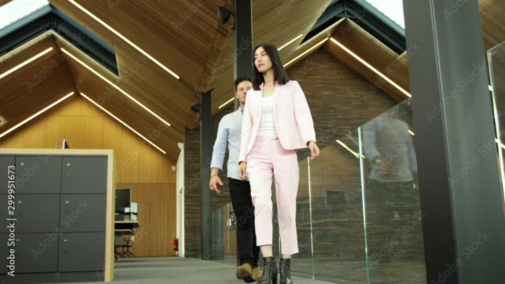 Stylish business couple strike a pose to camera in modern office ...