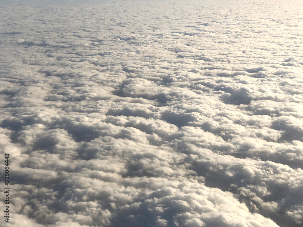 Flying above a thick layer of clouds, completely covering the terrain below. New Jersey and New ...