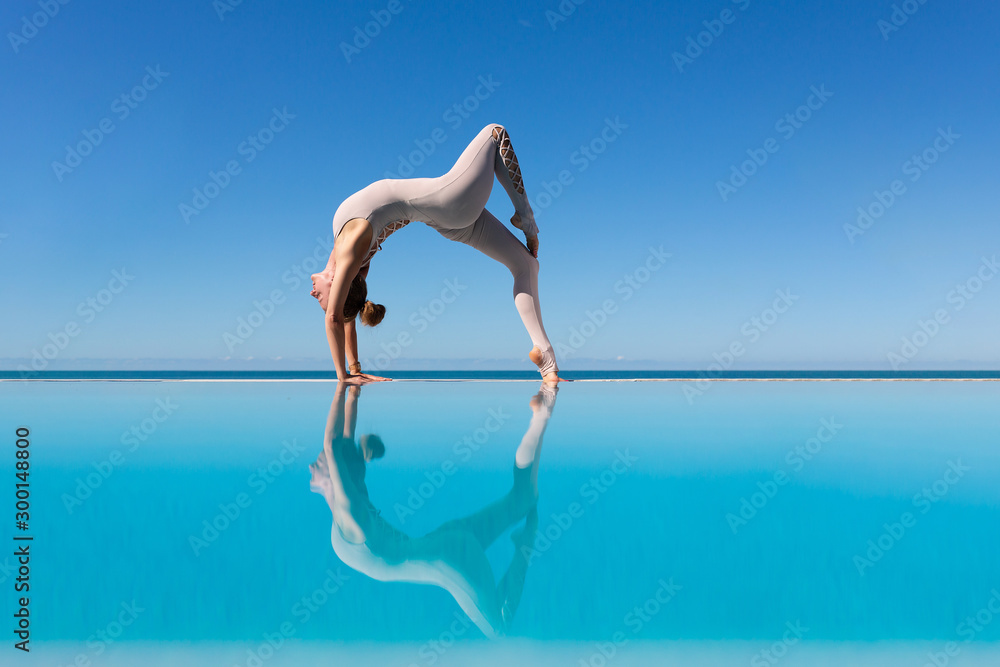 Beautiful athletic slim woman doing One legged Wheel exercise, Bridge ...