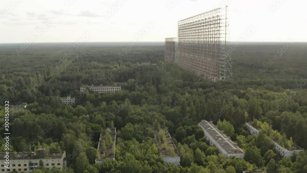 Rising aerial orbit around Duga Radar and abandoned buildings in ...