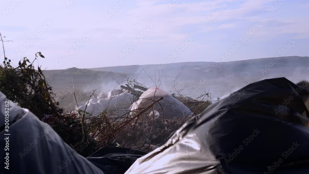 Trash and smoke representing a zone disaster and bad waste management ...