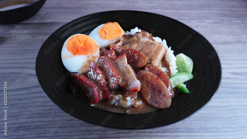 Barbecued red pork and crispy pork in sauce with rice or thai name Kao ...