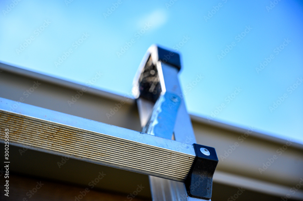 extension step ladder against side of roof Stock Photo | Adobe Stock