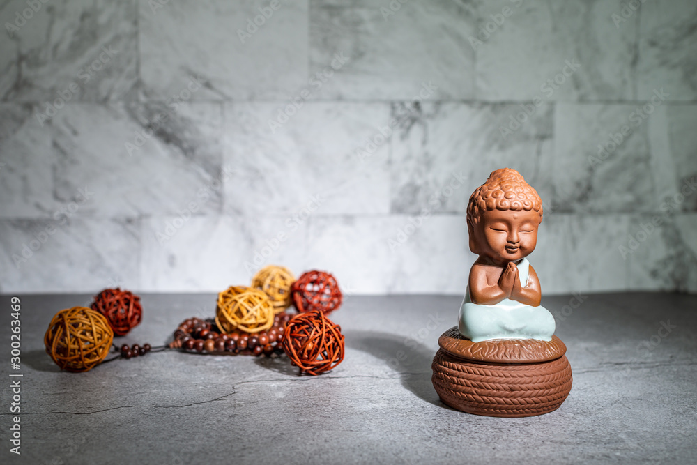 Monk sitting down praying statue home decoration ornament in spotlight ...