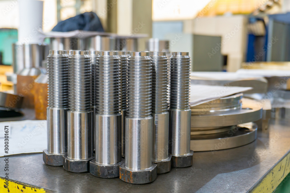 Bolts machined on a lathe from a hexagon in the machine shop. Stock ...