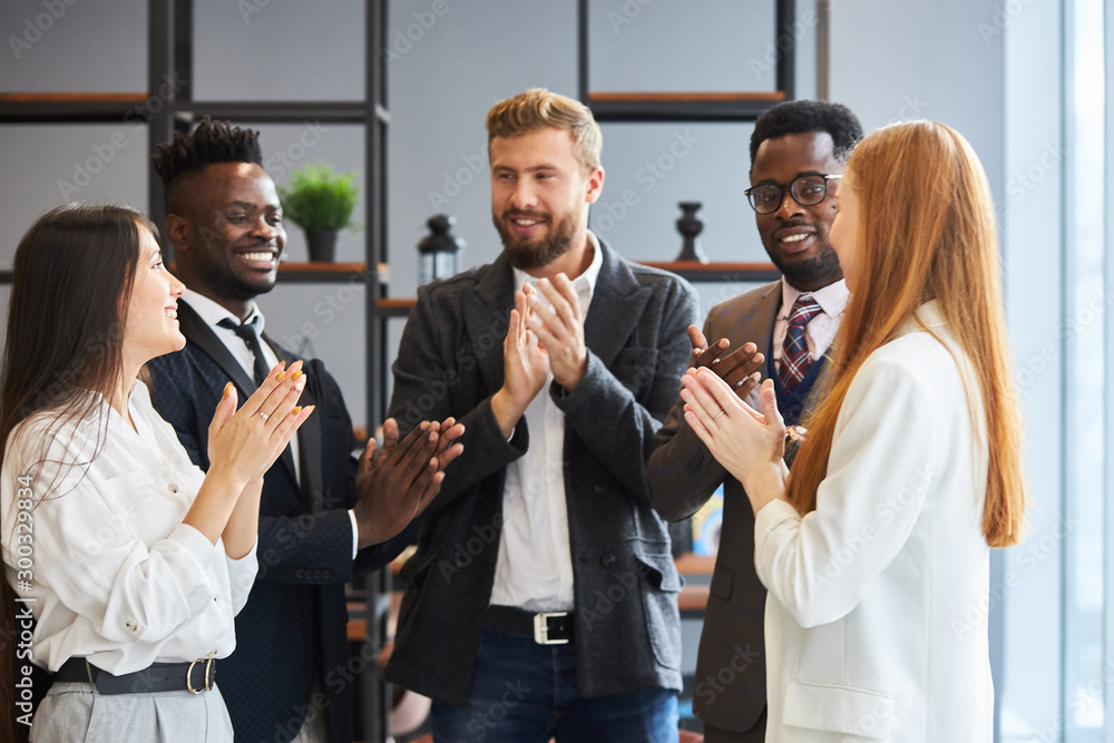 Caucasian and african young colleagues clapping after teamwork in ...