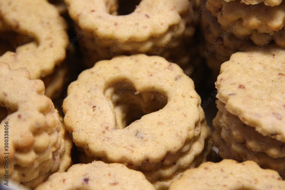 Stacked shortbread biscuits for linzer biscuits lie on white paper ...