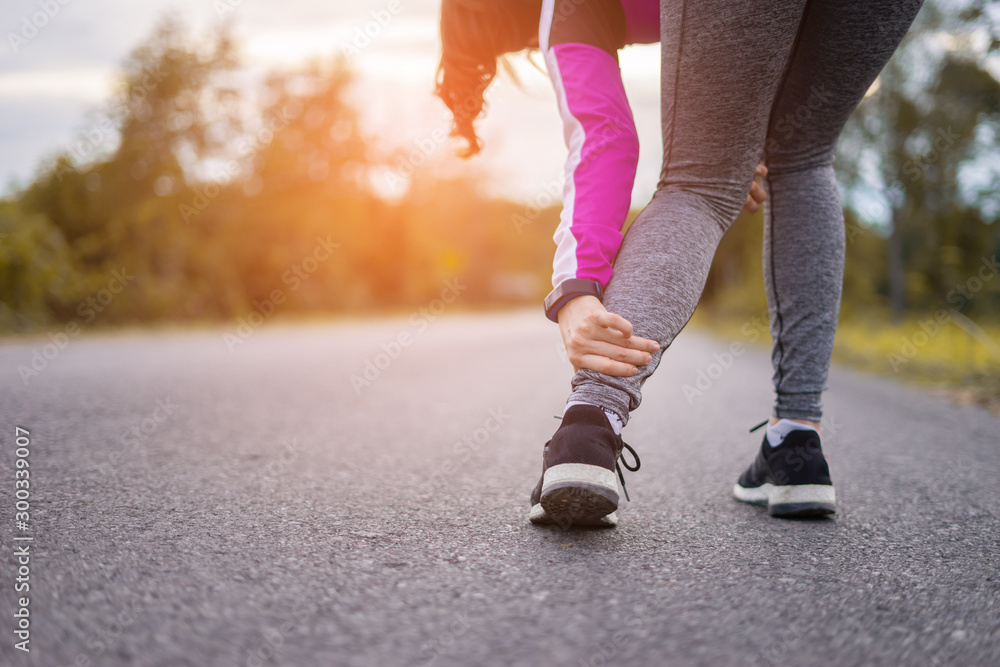 sport runner woman cramps in leg and feel pain, athletic young Asian ...