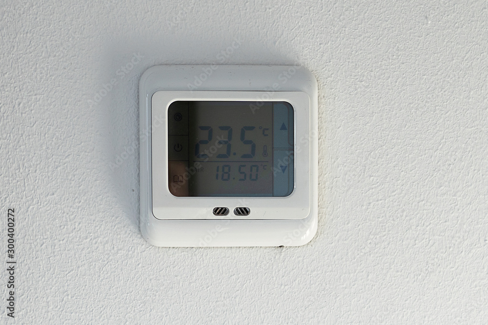 Wall-mounted display showing indoor and outdoor air temperature and ...