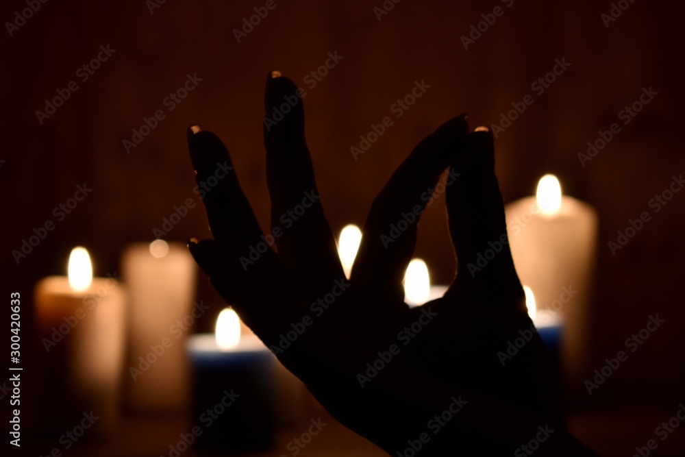 Candles and fingers mudra. Symbol of meditation folded fingers. The ...