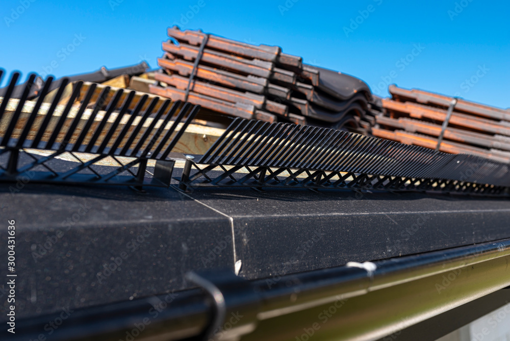 Roof ceramic tile arranged in packets on the roof on roof battens ...