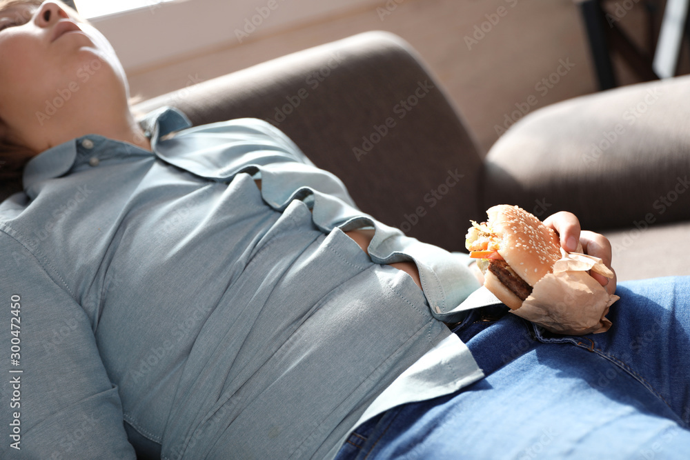 Overweight boy with burger sleeping on sofa at home Stock Photo | Adobe ...