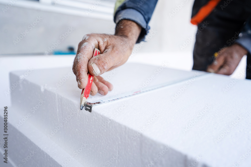 Worker use ruler measuring tape and pen to measure and mark the correct ...