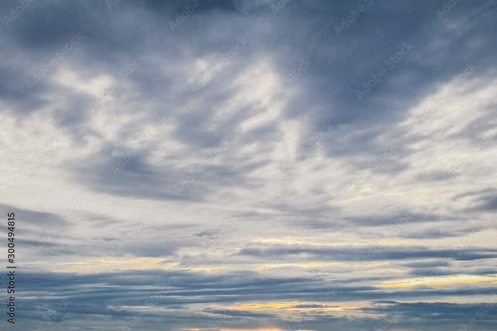light blue clouds. low evening overcast. weather change The dark sky ...