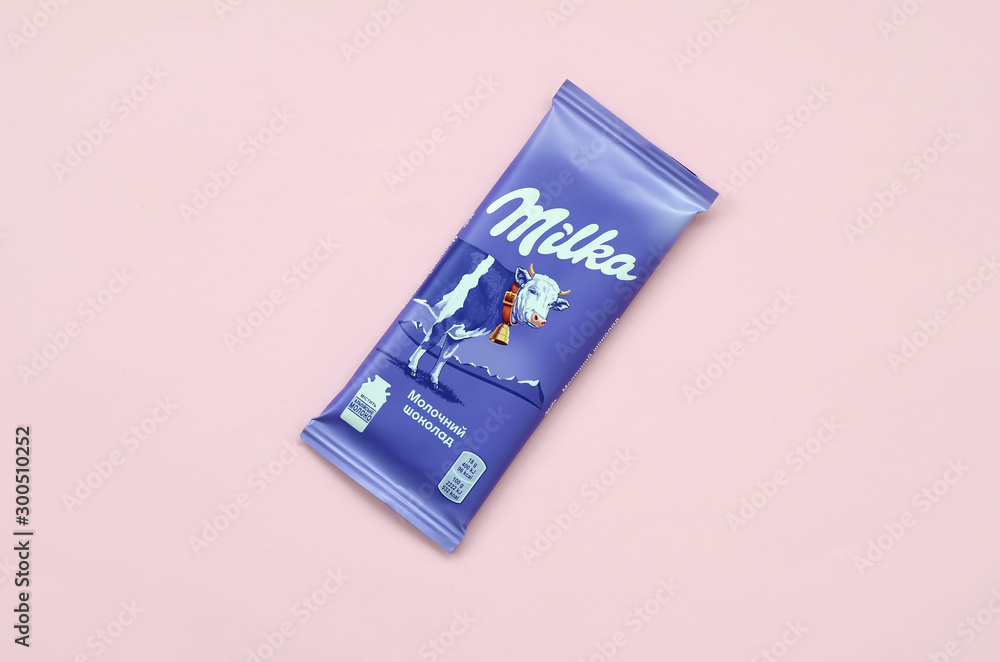 Milka chocolate tablet in classic violet wrapping on pastel pink ...