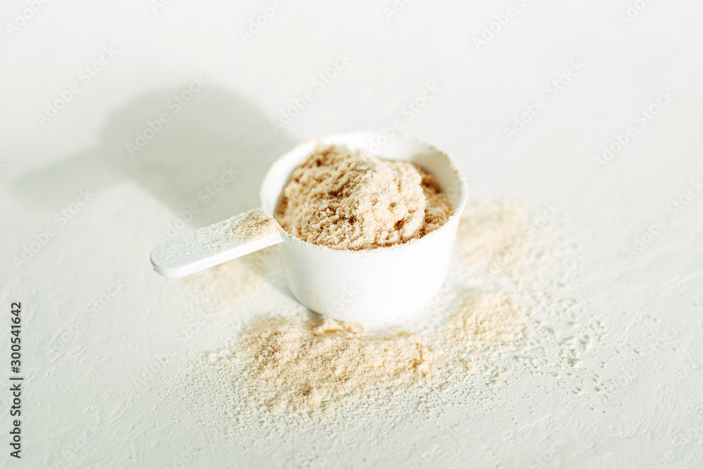 Scoop of protein powder on white background. Sports nutrition. Stock ...