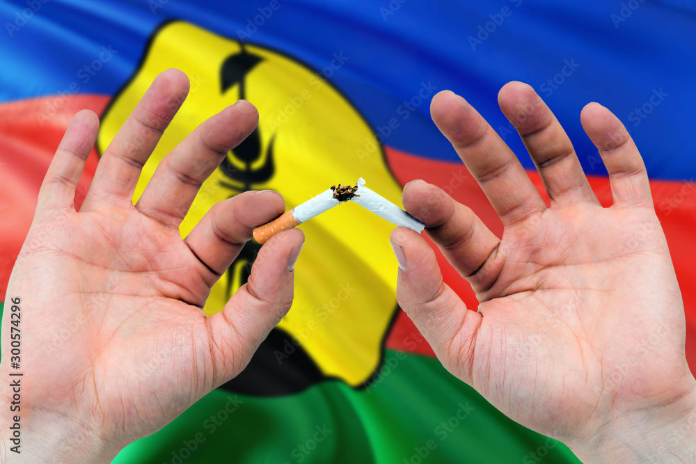New Caledonia quit smoking cigarettes concept. Adult man hands breaking ...