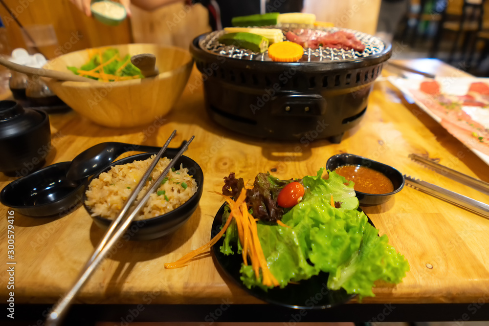 Yakiniku or Korean BBQ on mesh grill of charcoal fire table set. meat ...