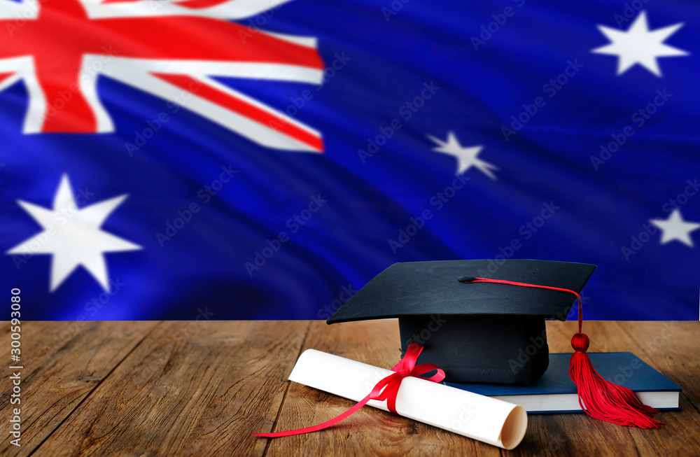 Australia education concept. Graduation cap and diploma on wooden table ...