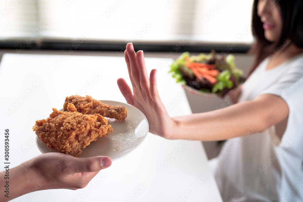 Girl rejecting junk food or unhealthy food choosing healthy food such ...