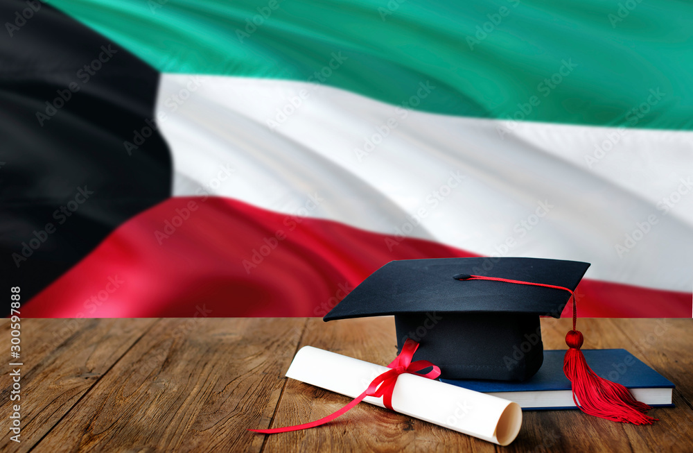 Kuwait education concept. Graduation cap and diploma on wooden table ...