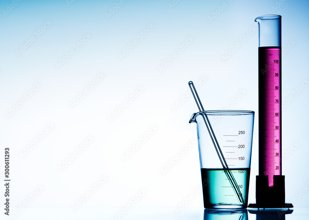 Different laboratory glassware with color liquid and with reflection ...