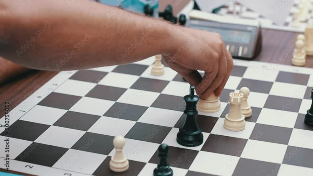 chess field, chess pieces, a man makes a move, clicks on the stopwatch ...