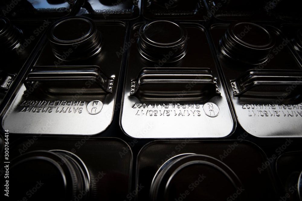 stainless steel jerry cans stacked in warehouse, close up with shallow ...