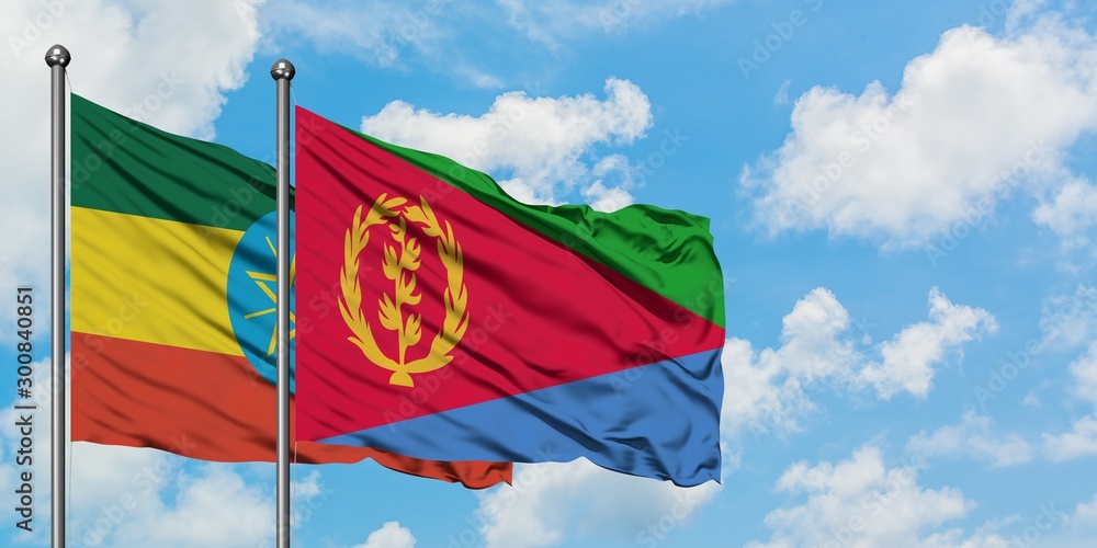Ethiopia and Eritrea flag waving in the wind against white cloudy blue ...