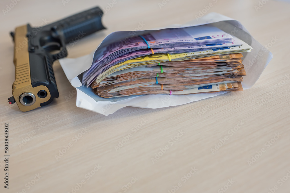 Black and gold gun pistol and money euros background Stock Photo ...