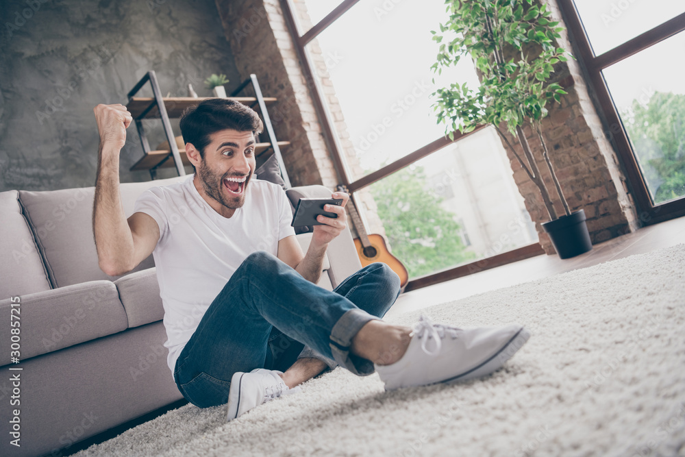 Hooray. Photo of mixed race crazy guy sitting floor leaning sofa ...