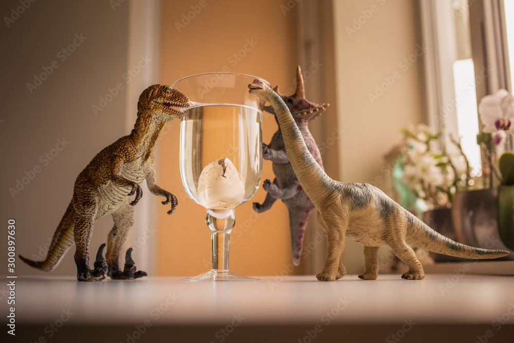 3 dinosaurs amazed with a view of baby dinosaur hatching from an egg ...