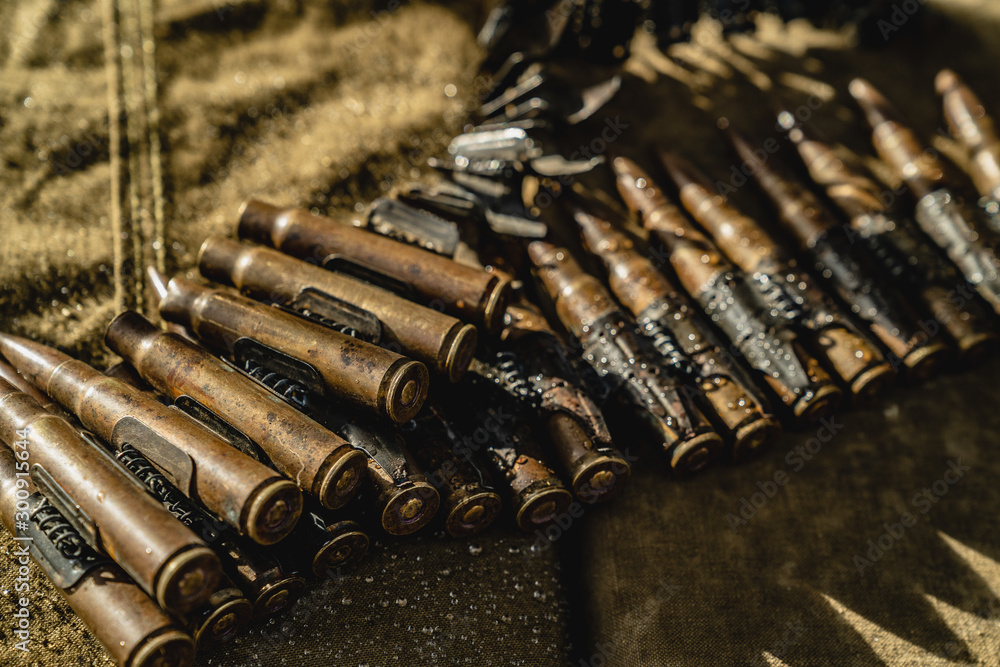 Machine gun bullets. Long bullets on the table. Military concept ...