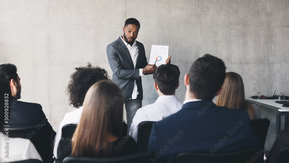 Top manager showing chart to colleagues, making presentation Stock ...