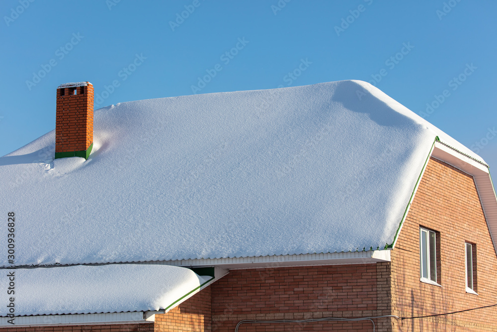 Brick house with snow on the roof Stock Photo | Adobe Stock